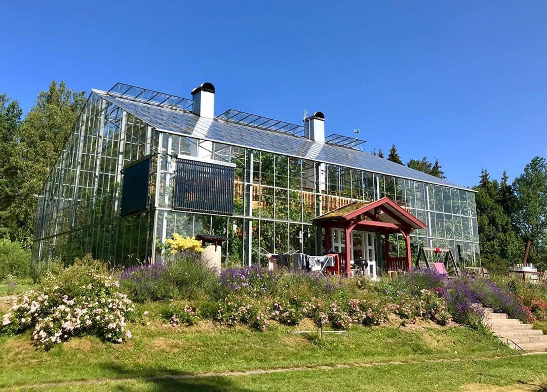 A Traditional Swedish Log Cabin Encased In A Green House Allows A ...